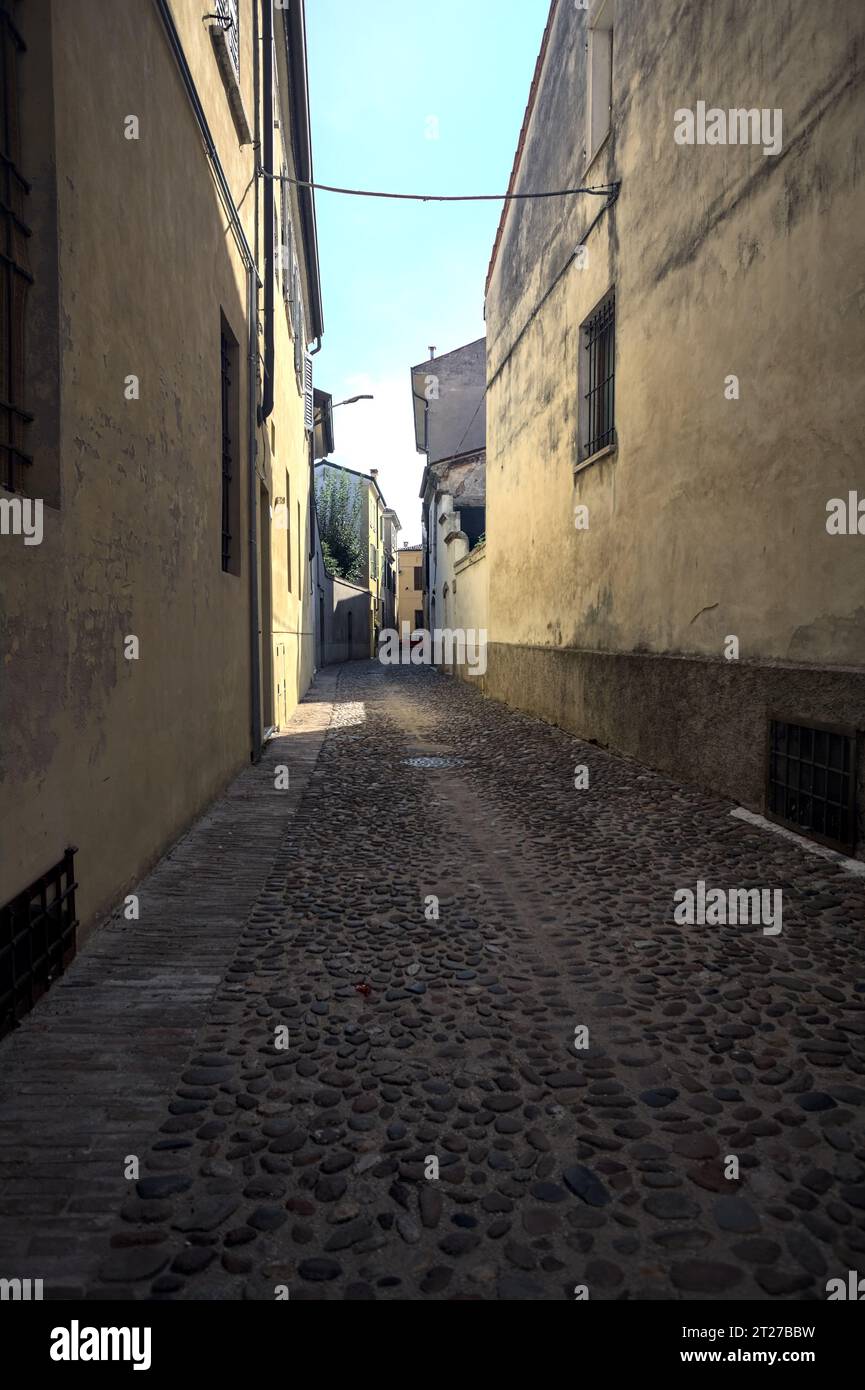 Cobbled alley partlially in the shade in an italian town Stock Photo ...