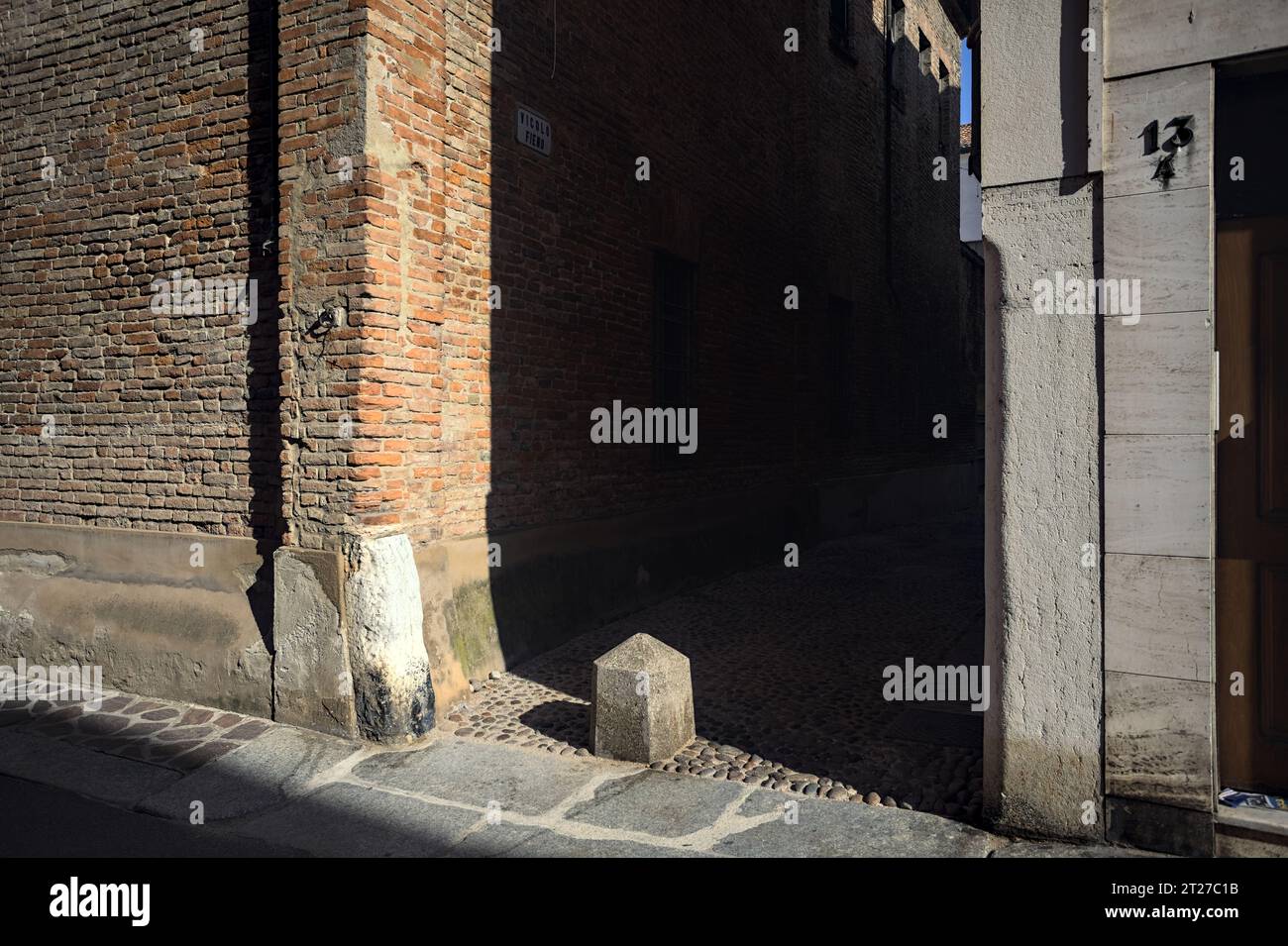 Corner of a street with a cobbled alley in an italian town Stock Photo ...