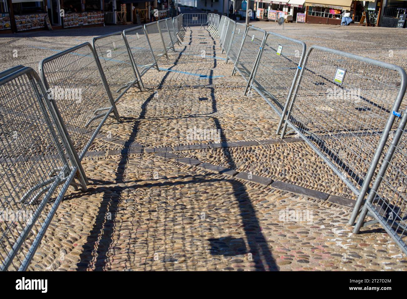 Madrid, Spain - October 10, 23: Metal fences create a narrow path to ...