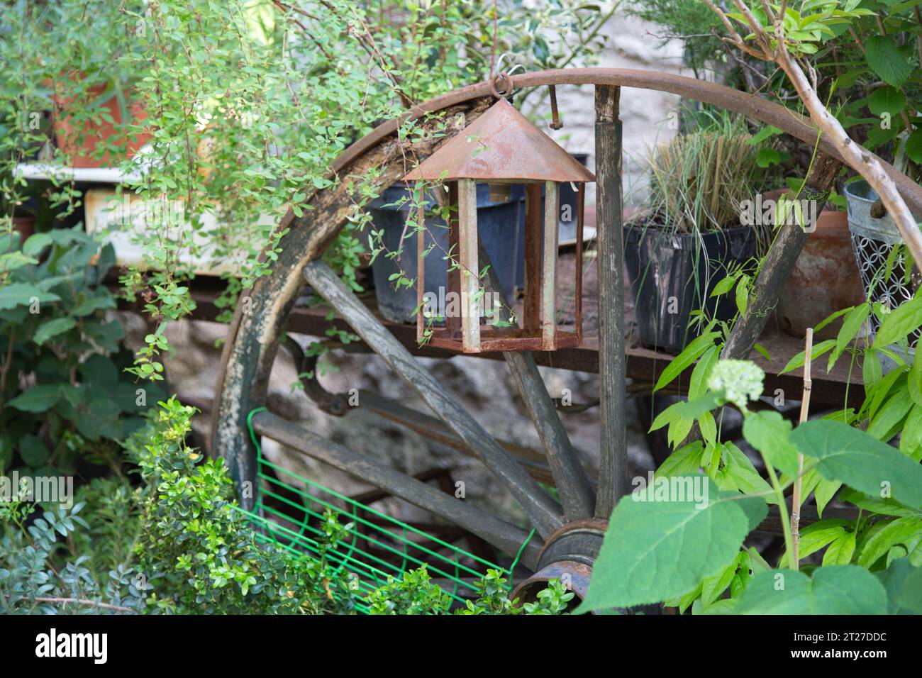 An old wooden wheel and a lantern Stock Photo - Alamy