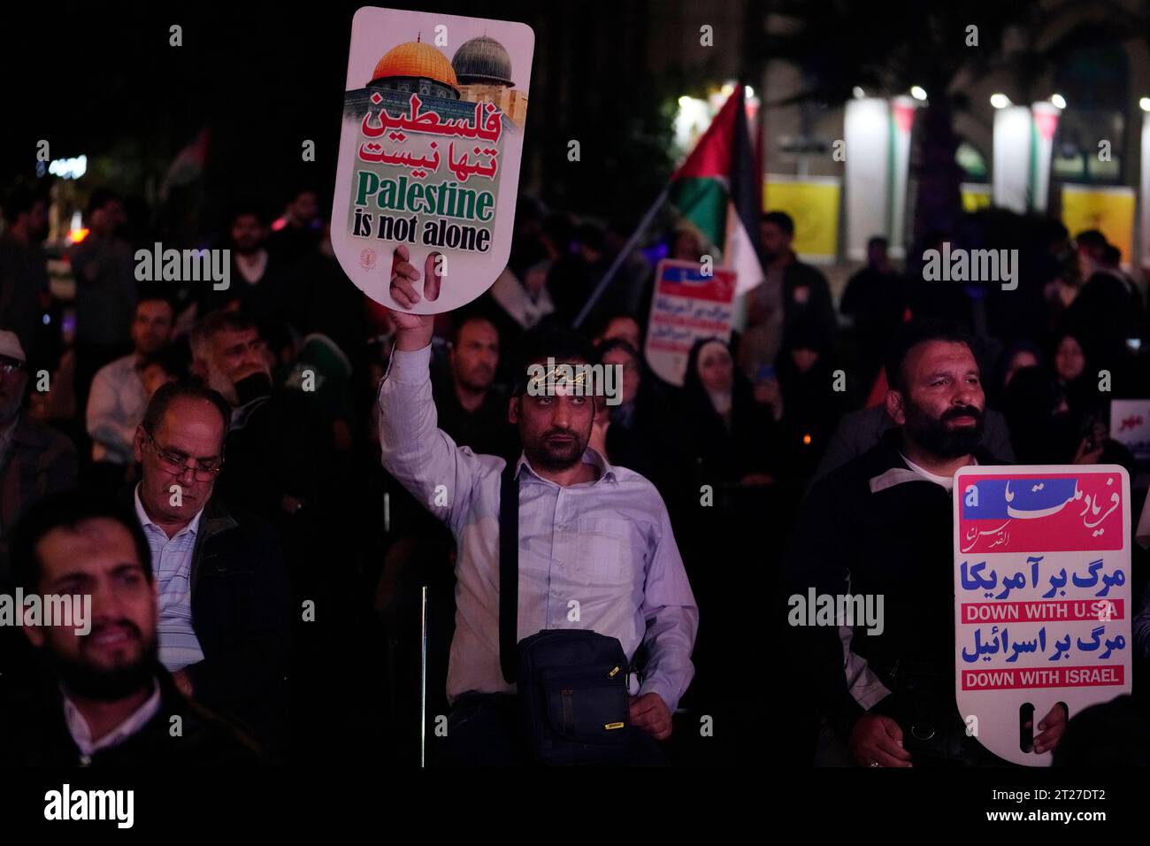A demonstrator holds a placard with photos of Al-Aqsa Mosque and Dome ...