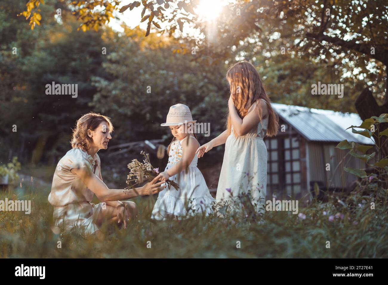 Mother and daughters enjoying a sunny weather in nature Stock Photo - Alamy
