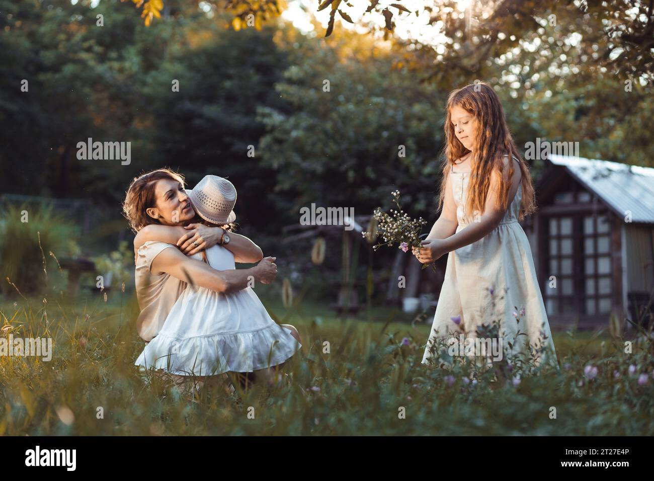Mother and daughters enjoying a sunny weather in nature Stock Photo - Alamy