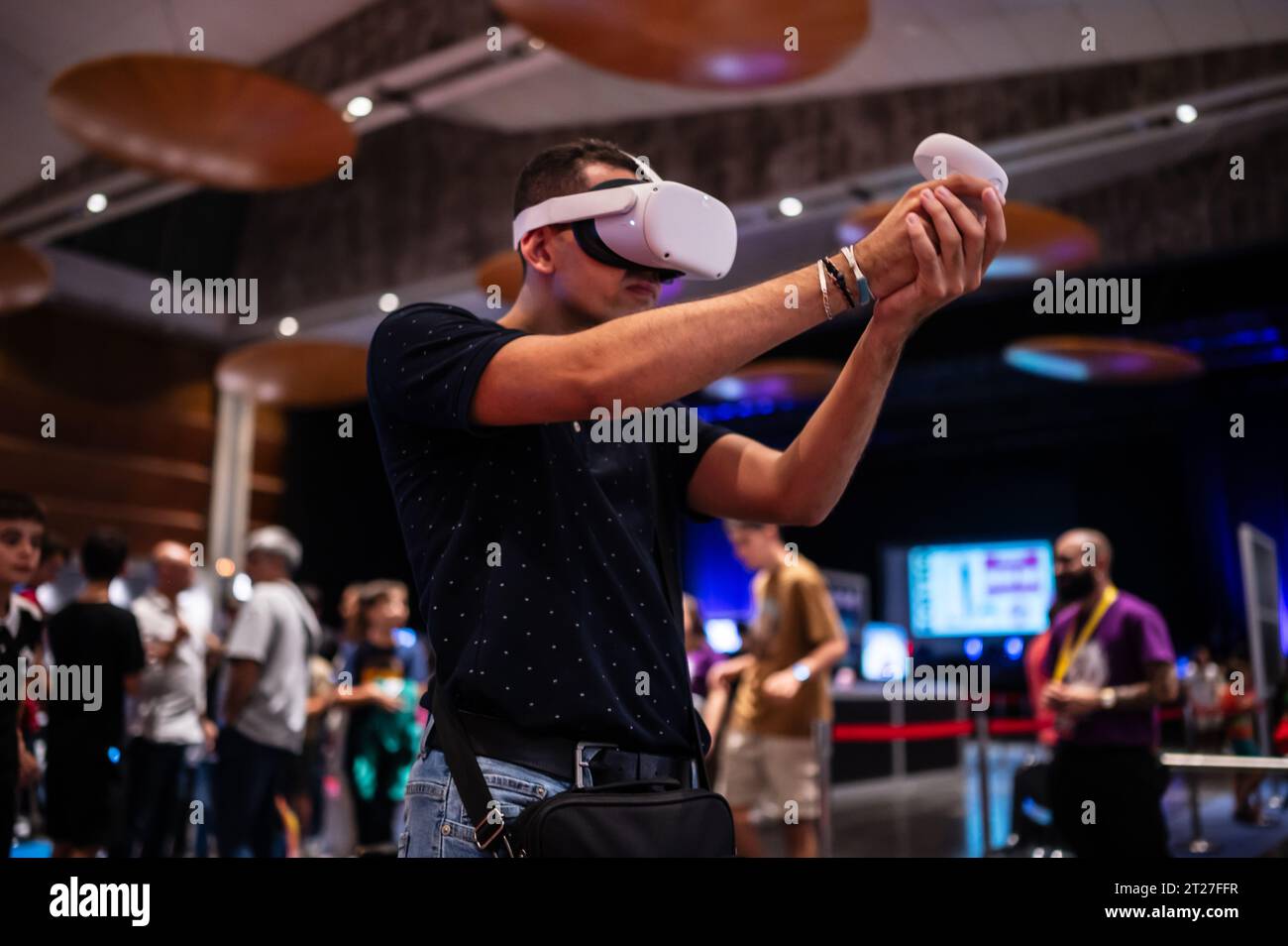 Young man playing with Meta Quest 2 all-in-one VR headset during ZGamer ...