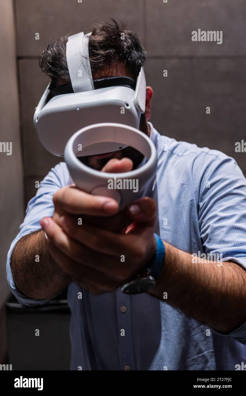 Young man playing with Meta Quest 2 all-in-one VR headset during ZGamer ...
