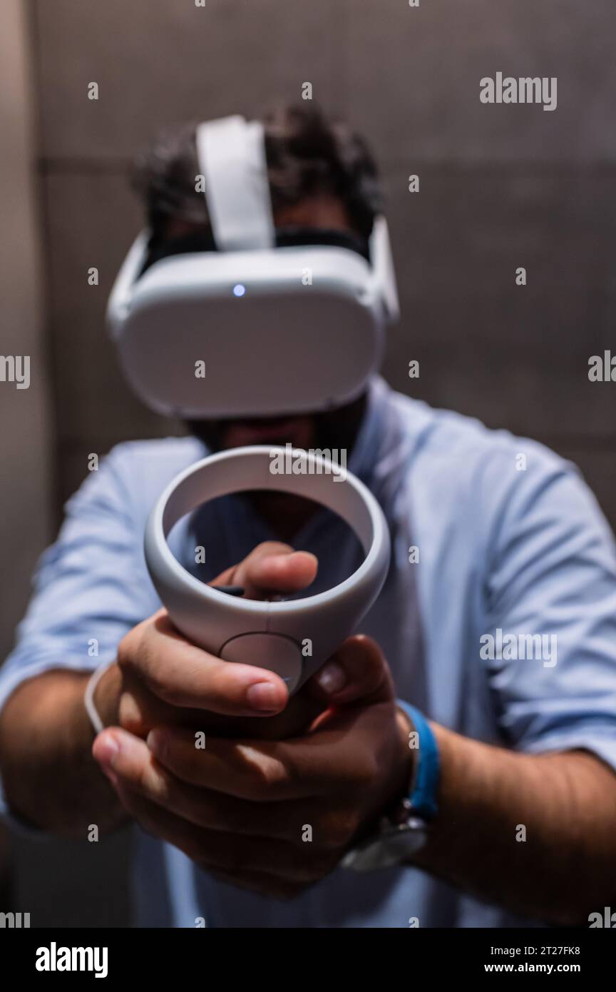 Young man playing with Meta Quest 2 all-in-one VR headset during ZGamer ...