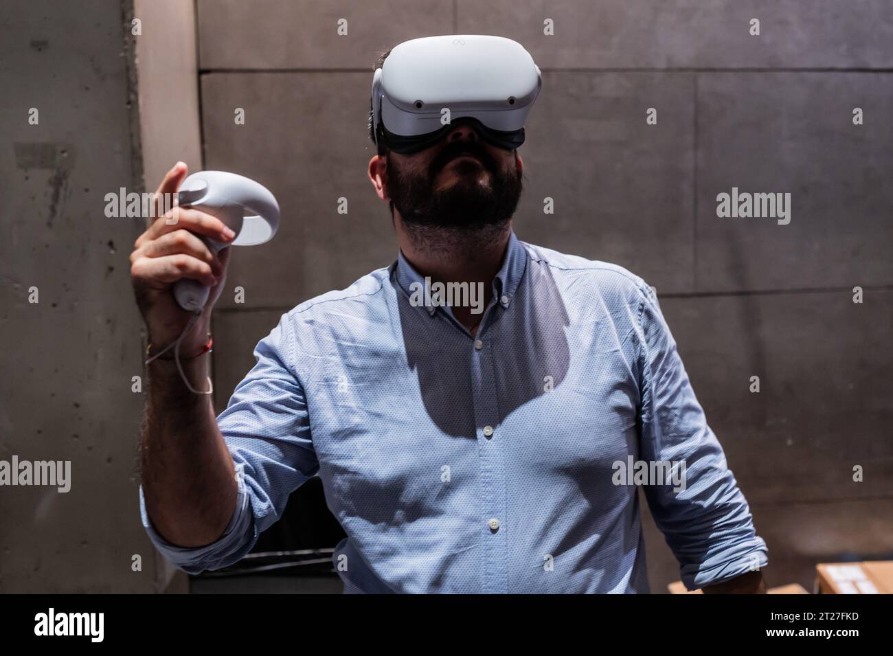 Young man playing with Meta Quest 2 all-in-one VR headset during ZGamer ...