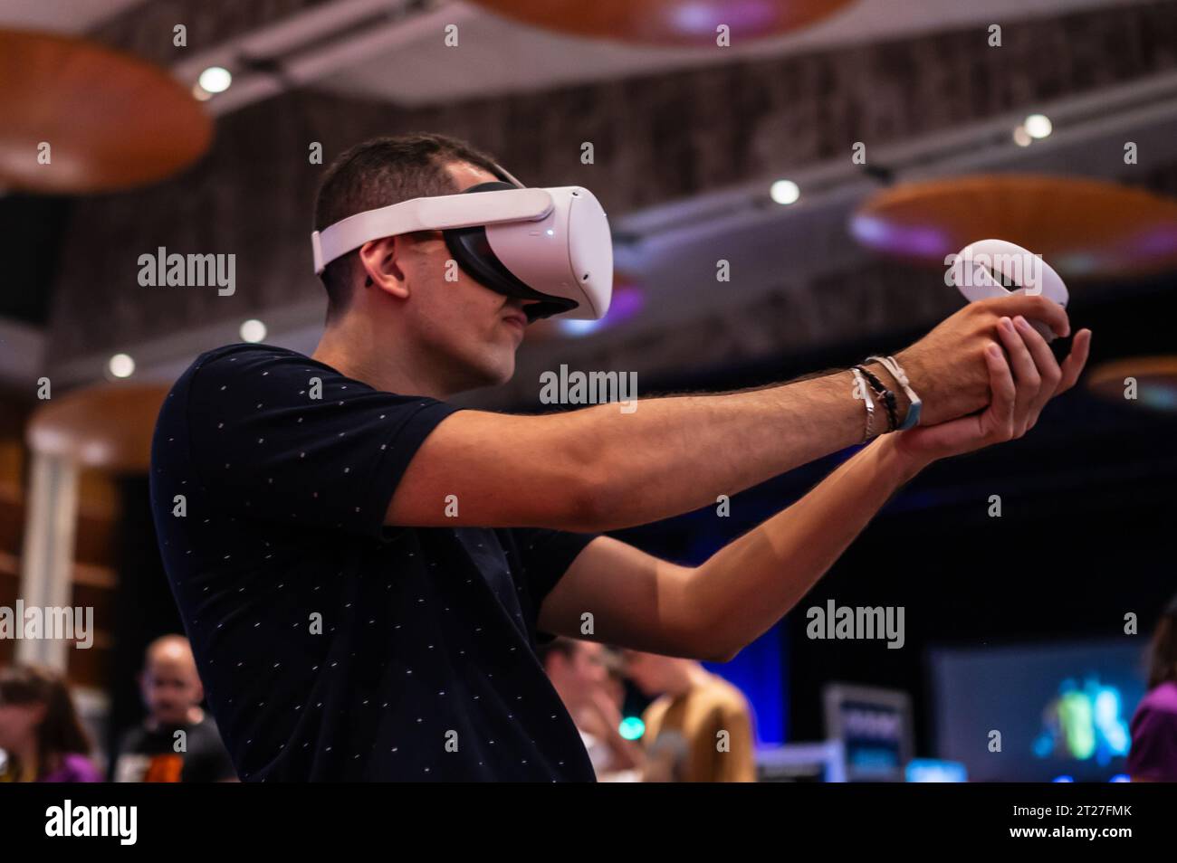 Young man playing with Meta Quest 2 all-in-one VR headset during ZGamer ...