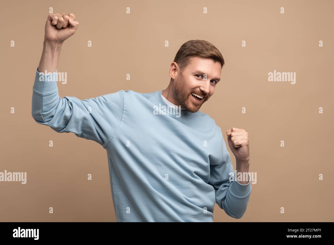 Man rejoices raising fists up smile happily, emotionally expressively ...