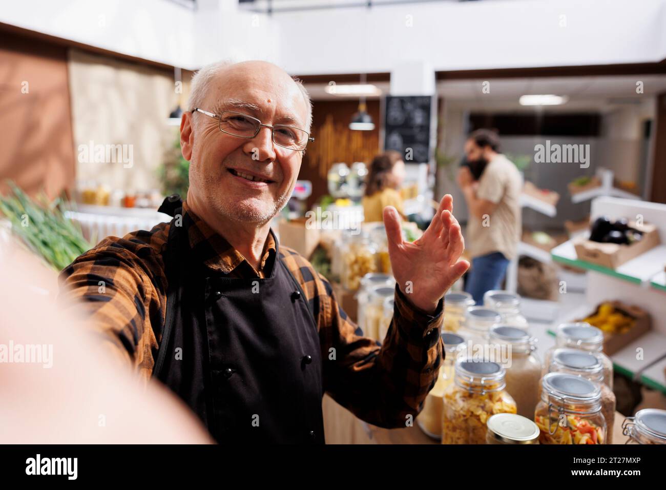 Zero waste shop elderly entrepreneur using selfie camera to promote ...