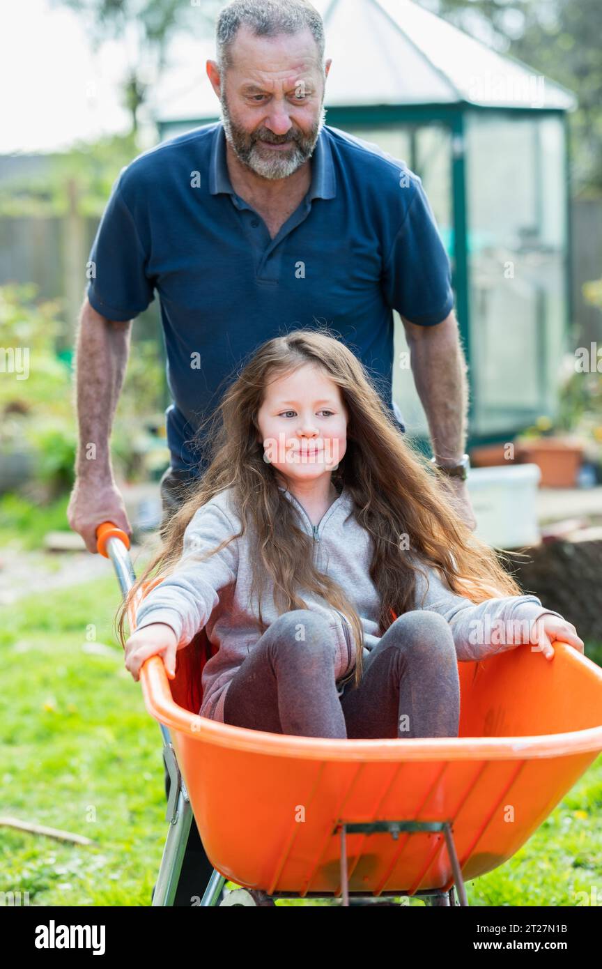 Riding in a wheelbarrow hi-res stock photography and images - Alamy