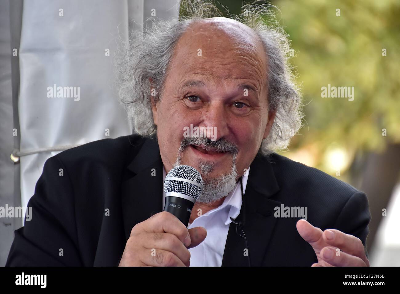 Richard Martin is seen speaking on the microphone in Marseille. Richard ...