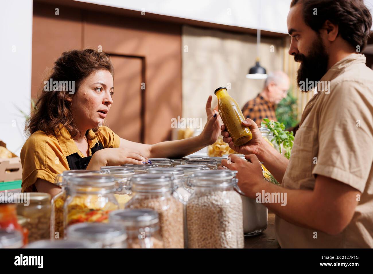 Farmer showcasing her products in zero waste marketplace venue, trading ...