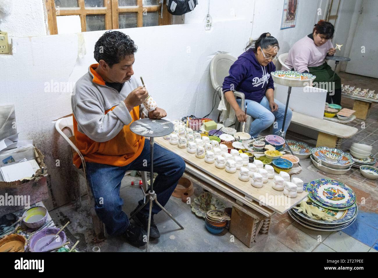 Mexican crafts people hand paint ceramic items at Gorky Gonzales ...