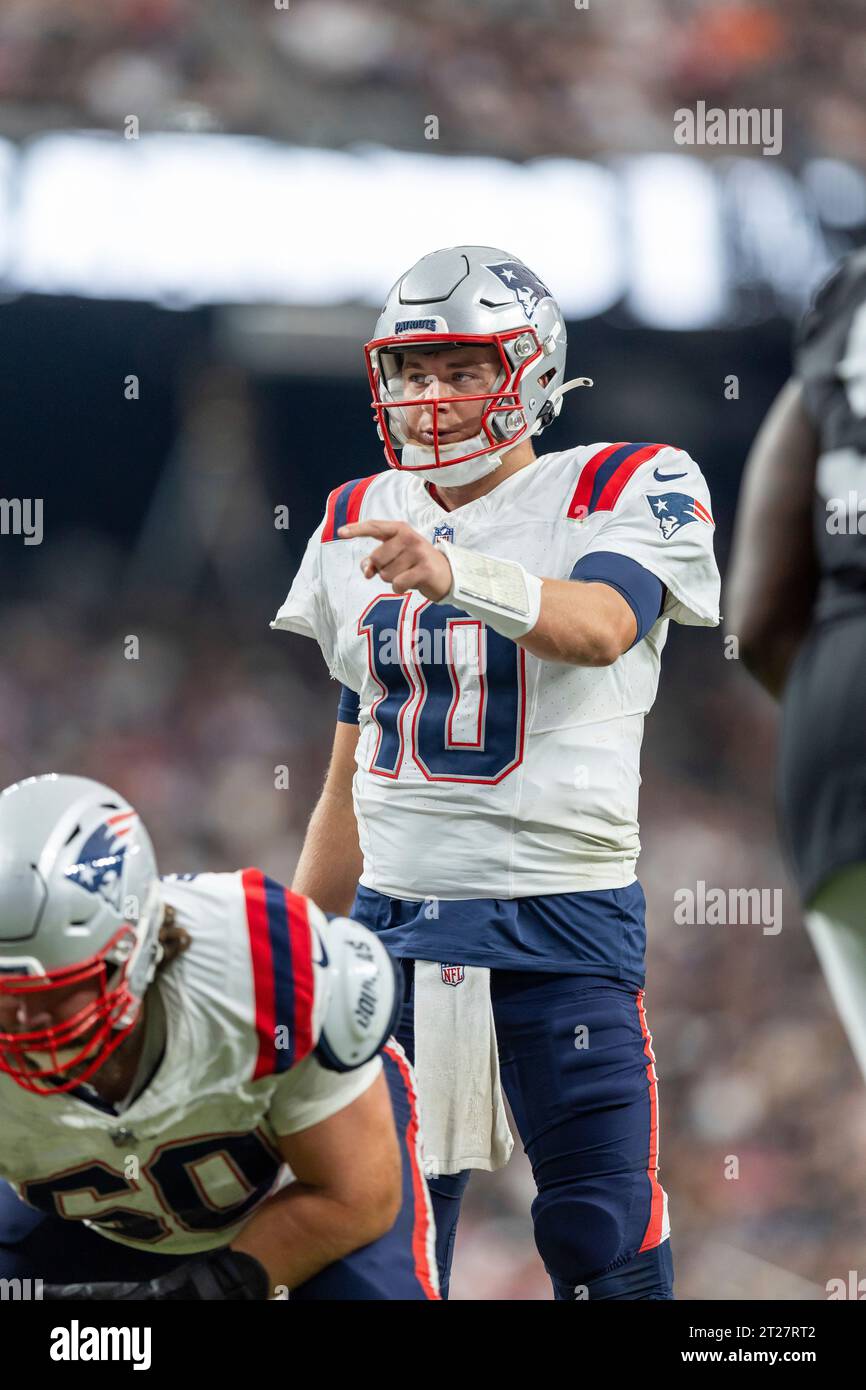 New England Patriots quarterback Mac Jones (10) audibles against the ...