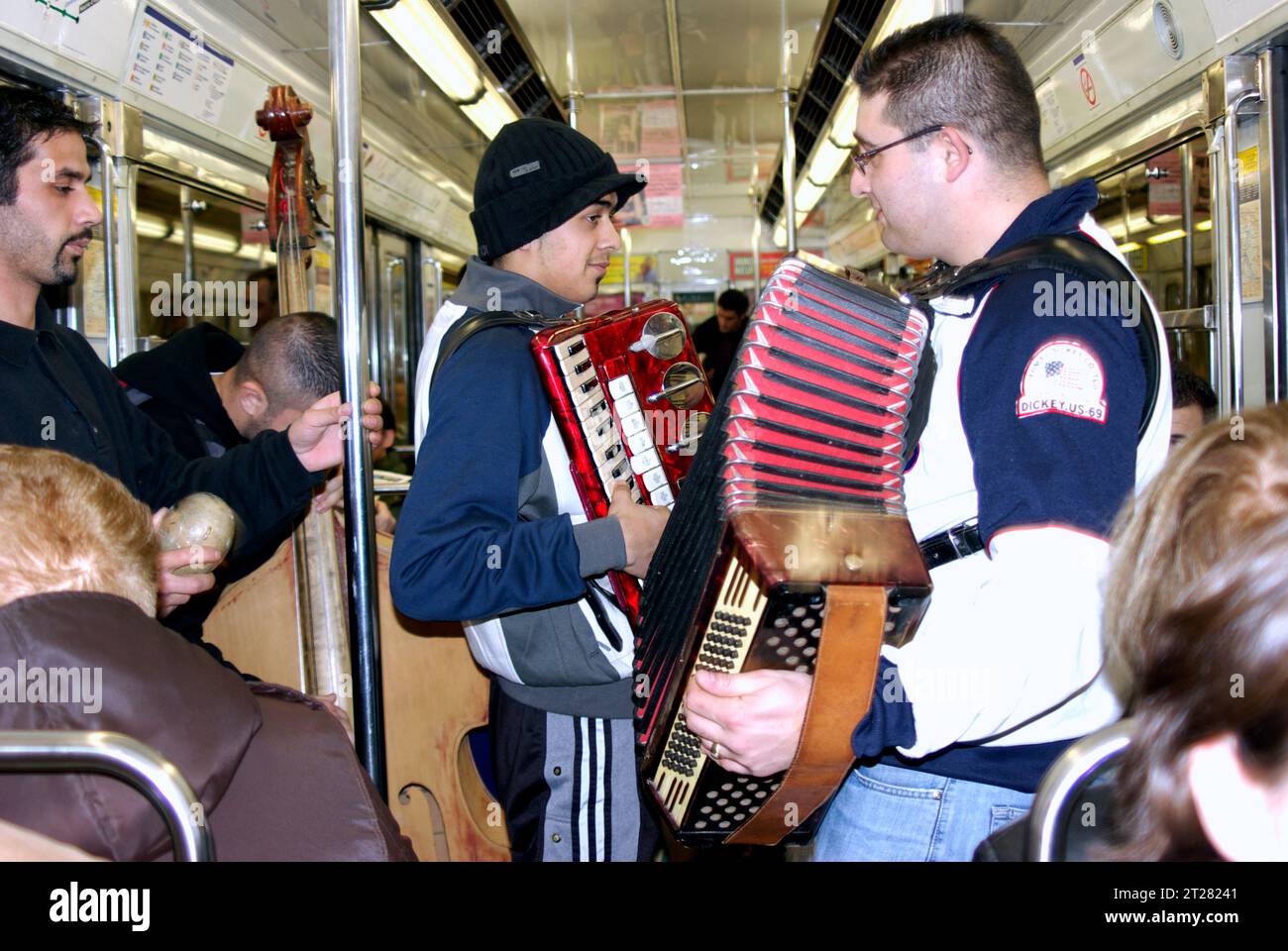 Male musicians busking in a tube train in the Paris underground Stock ...