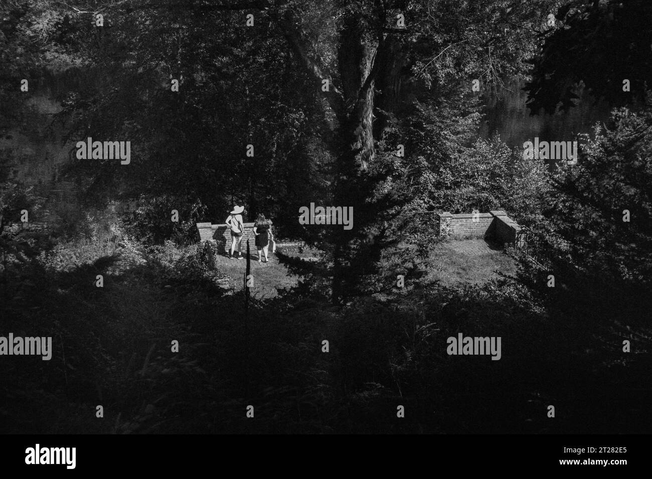 Two women view the Concord River over a brick wall overlook at North ...