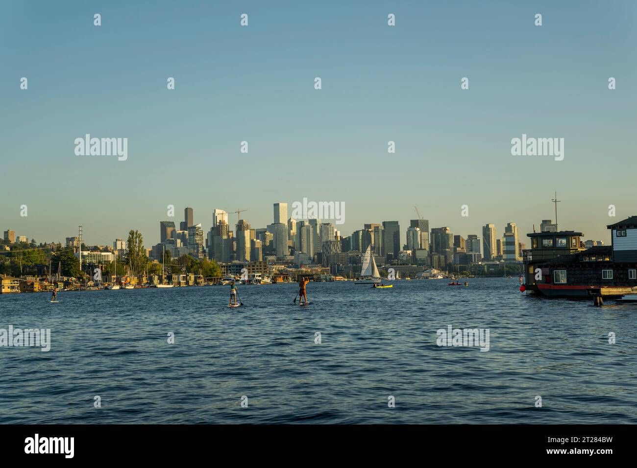 People paddle boarding and kayaking on Lake Union with the Seattle ...