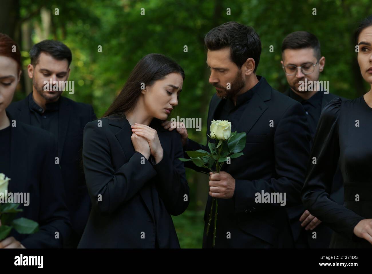 Funeral ceremony. Sad people in black clothes mourning outdoors Stock ...
