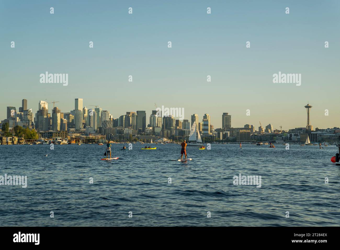 People paddle boarding and kayaking on Lake Union with the Seattle ...