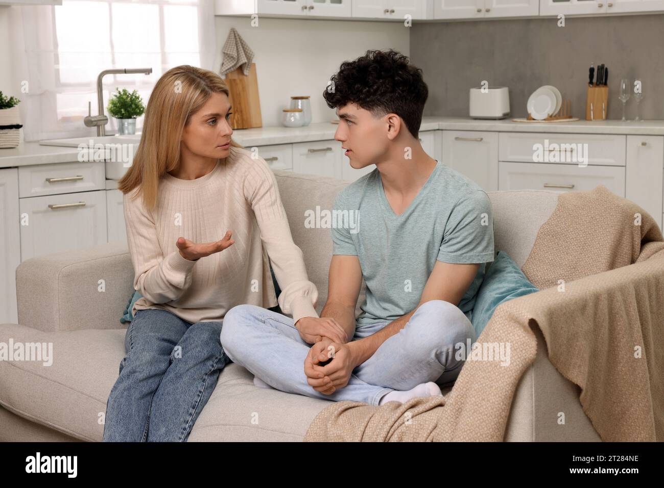 Mother consoling her upset son at home. Teenager problems Stock Photo ...