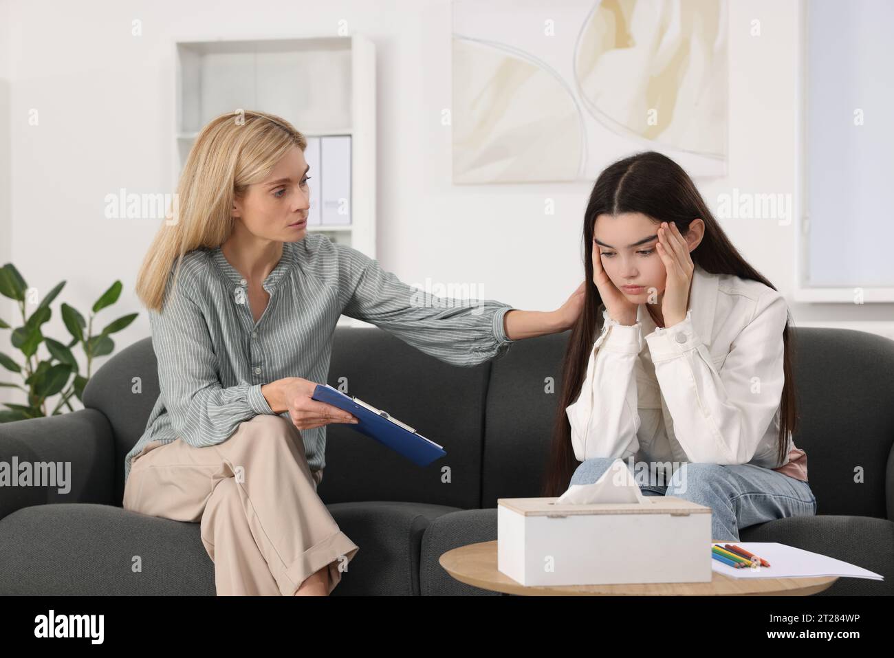 Psychologist working with teenage girl in office. Teenager problems ...