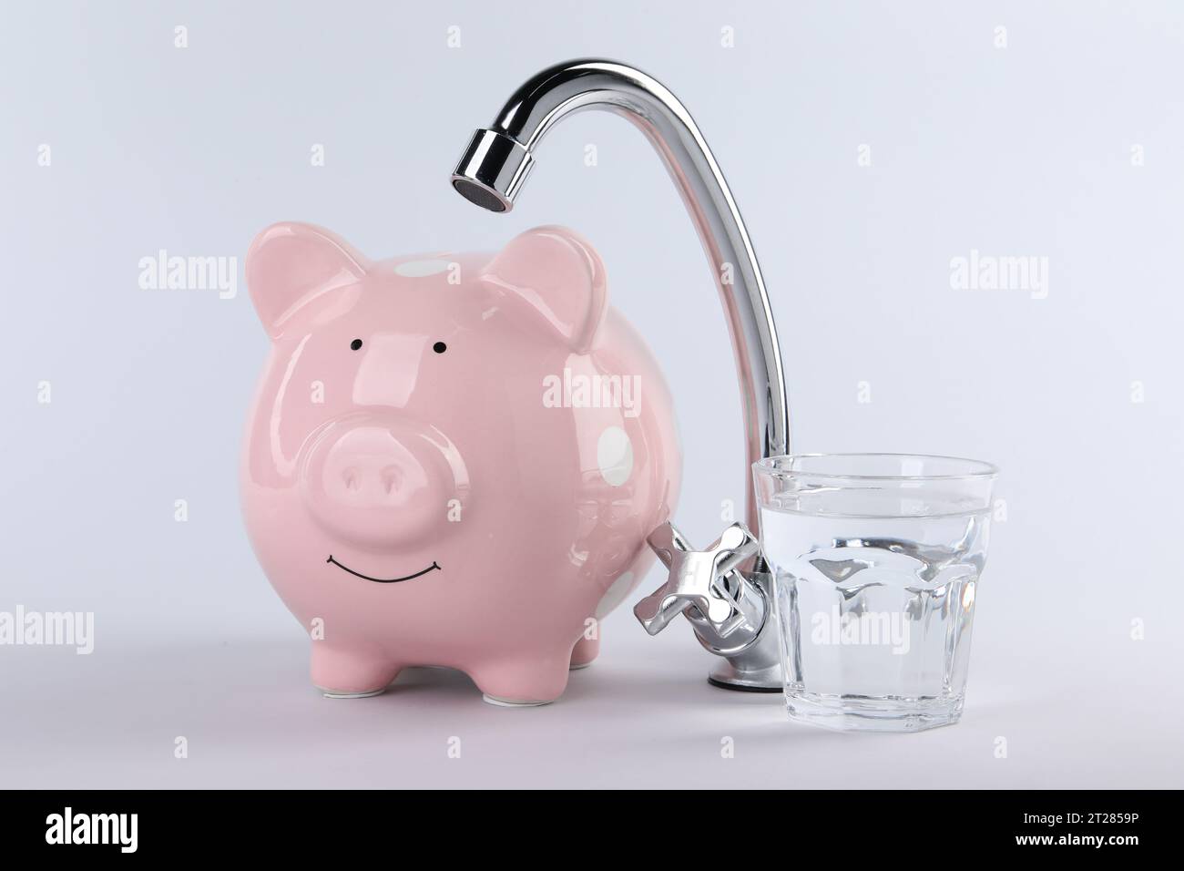 Water scarcity concept. Piggy bank, tap and glass of drink isolated on ...