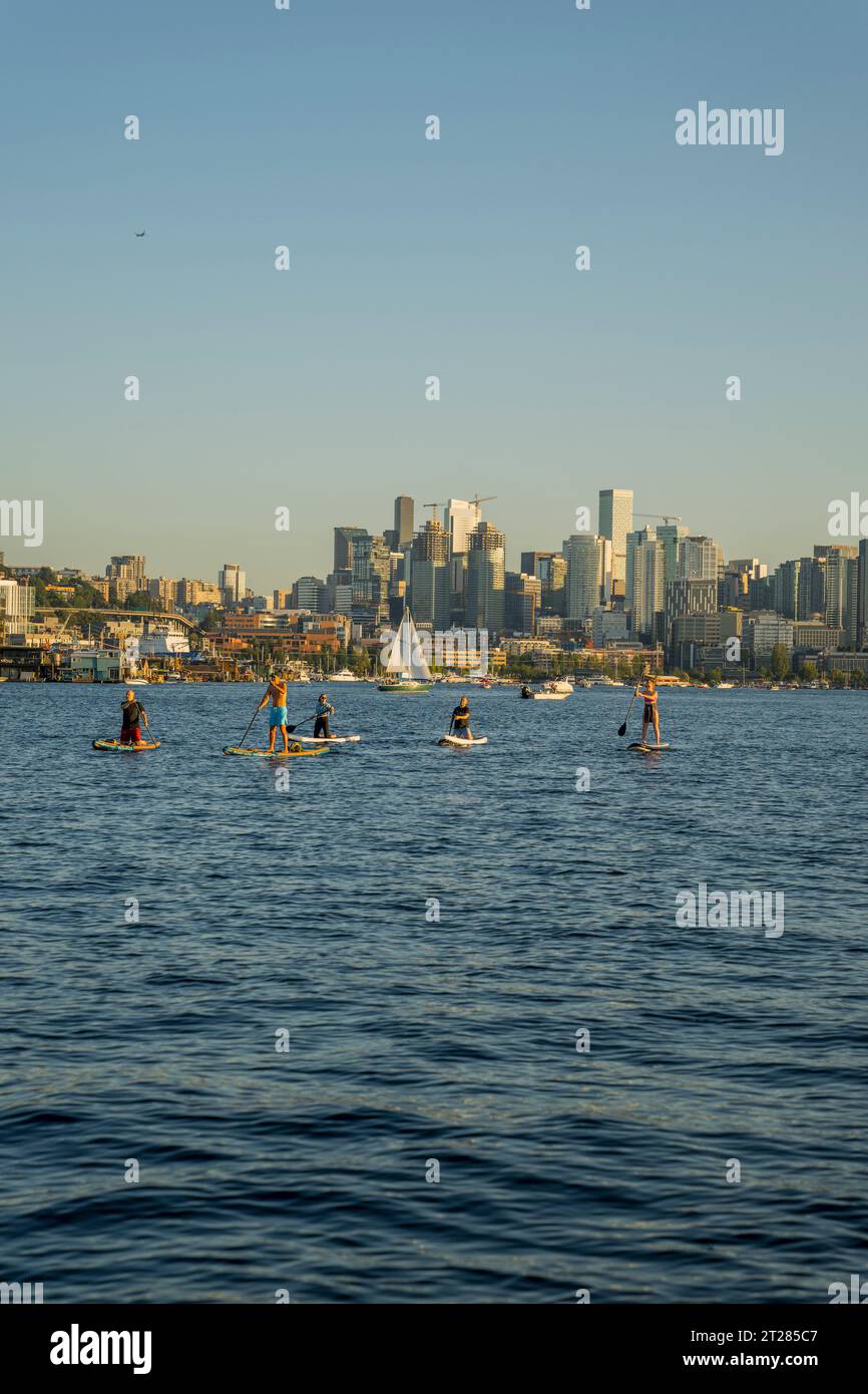 People paddle boarding on Lake Union with the Seattle skyline in ...