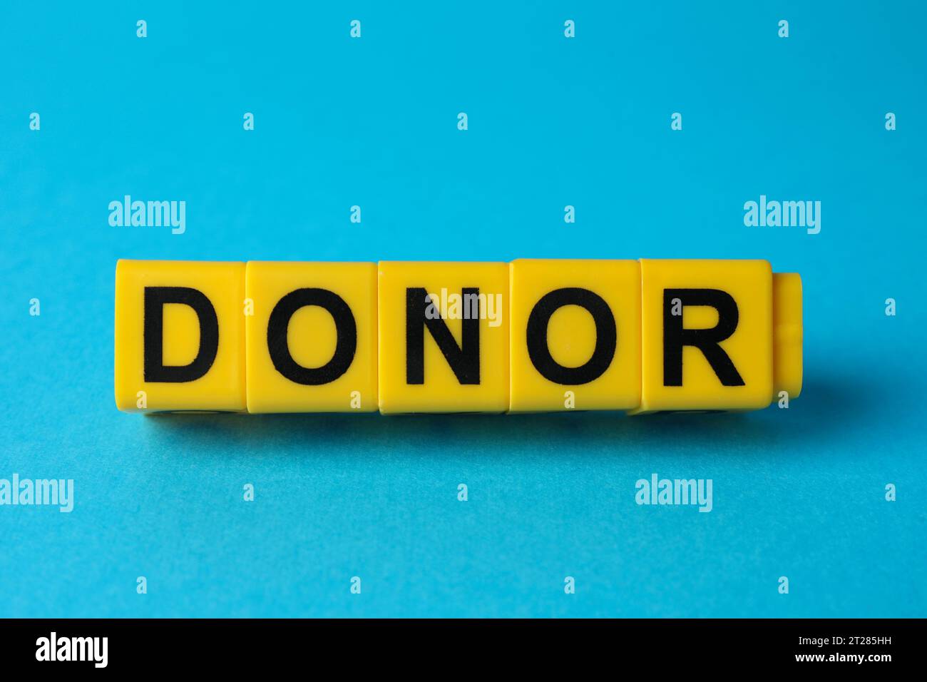 Word Donor made of cubes on light blue background Stock Photo - Alamy