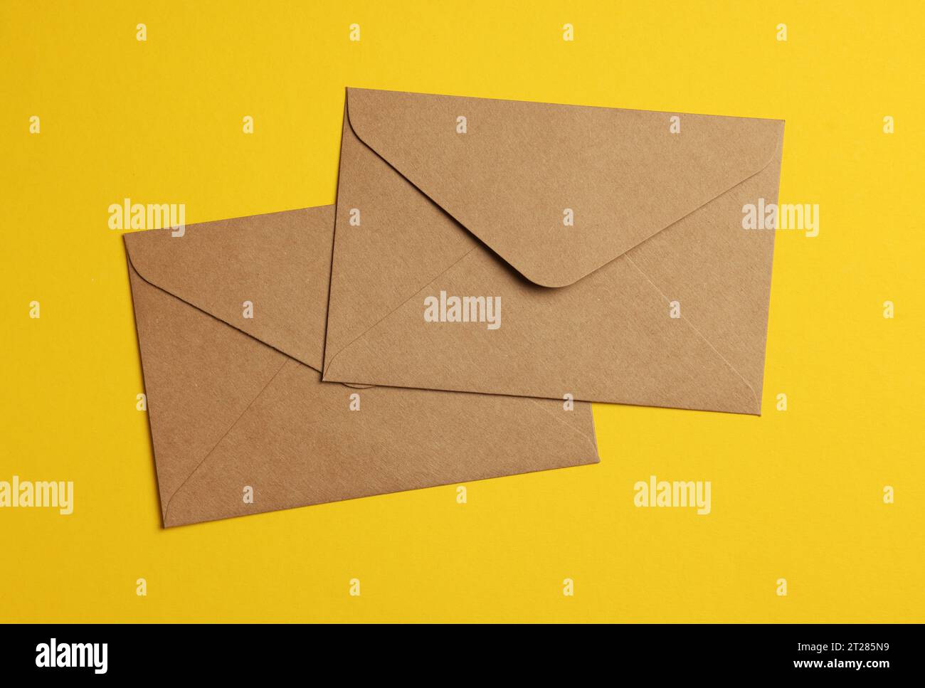 Envelopes made of parchment paper on yellow background, flat lay Stock ...