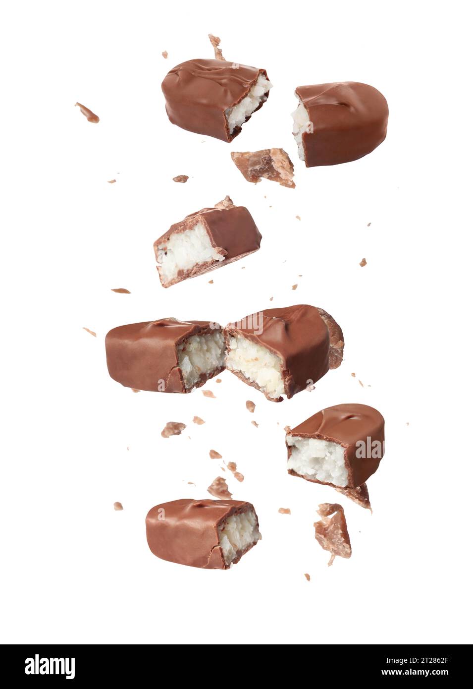 Pieces of delicious chocolate bars with coconut filling falling on ...