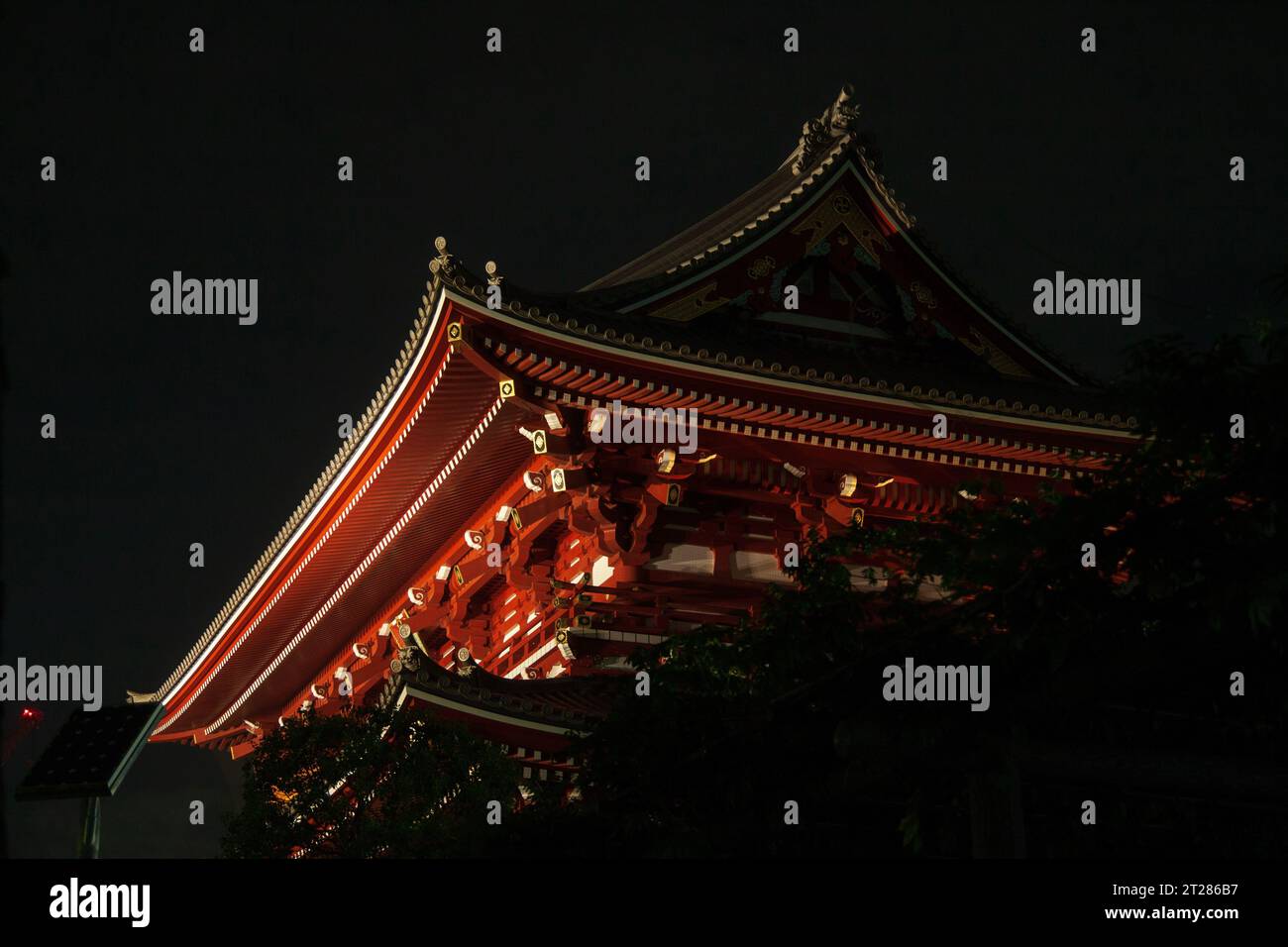 A majestic traditional Japanese building illuminated by glowing lights ...