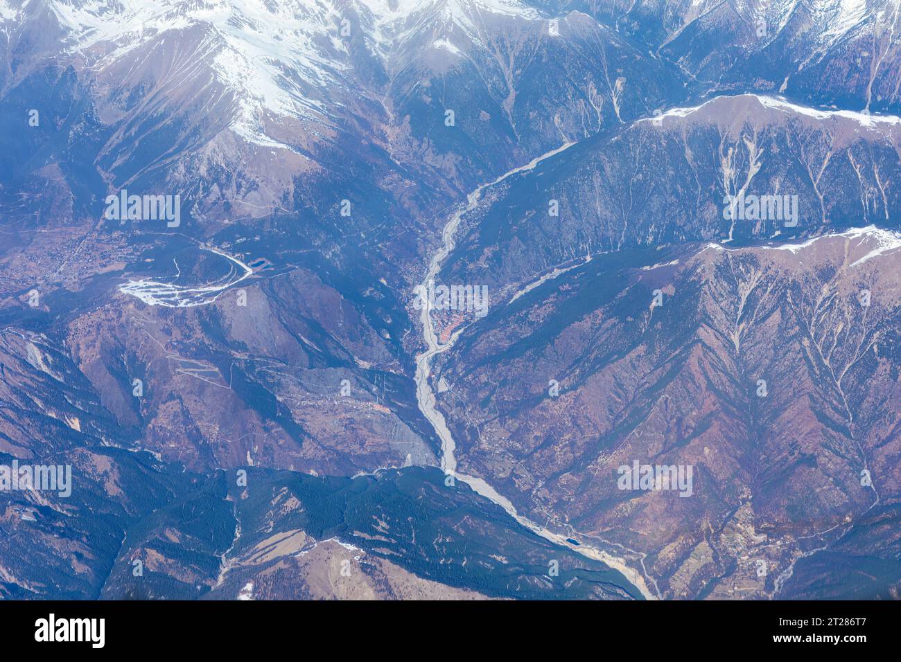 Aerial view of Alps mountains and river. View from airplane window ...
