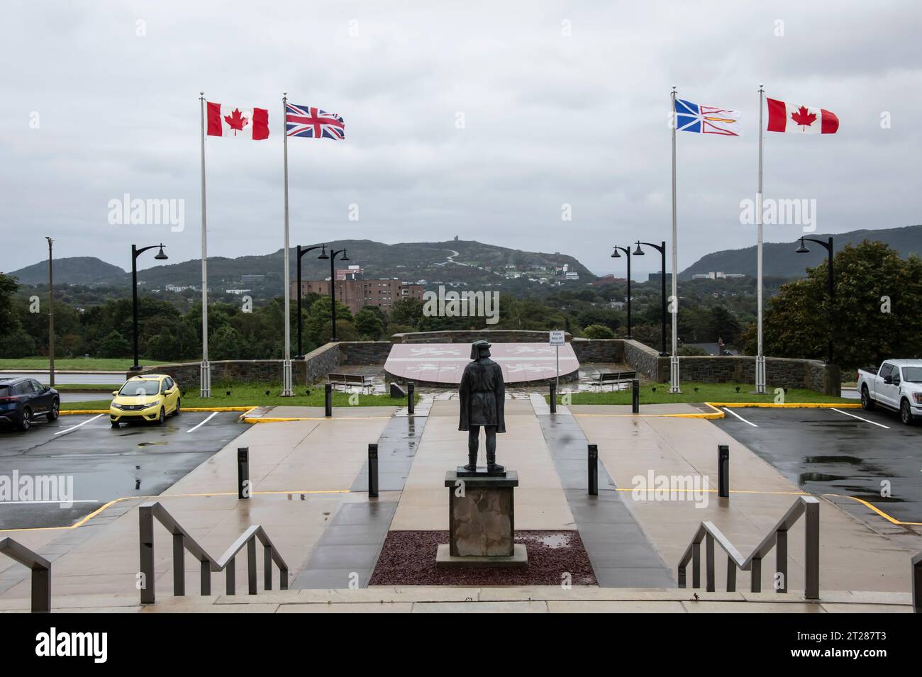 Flags and statue of John Cabot in the parking lot of the provincial ...