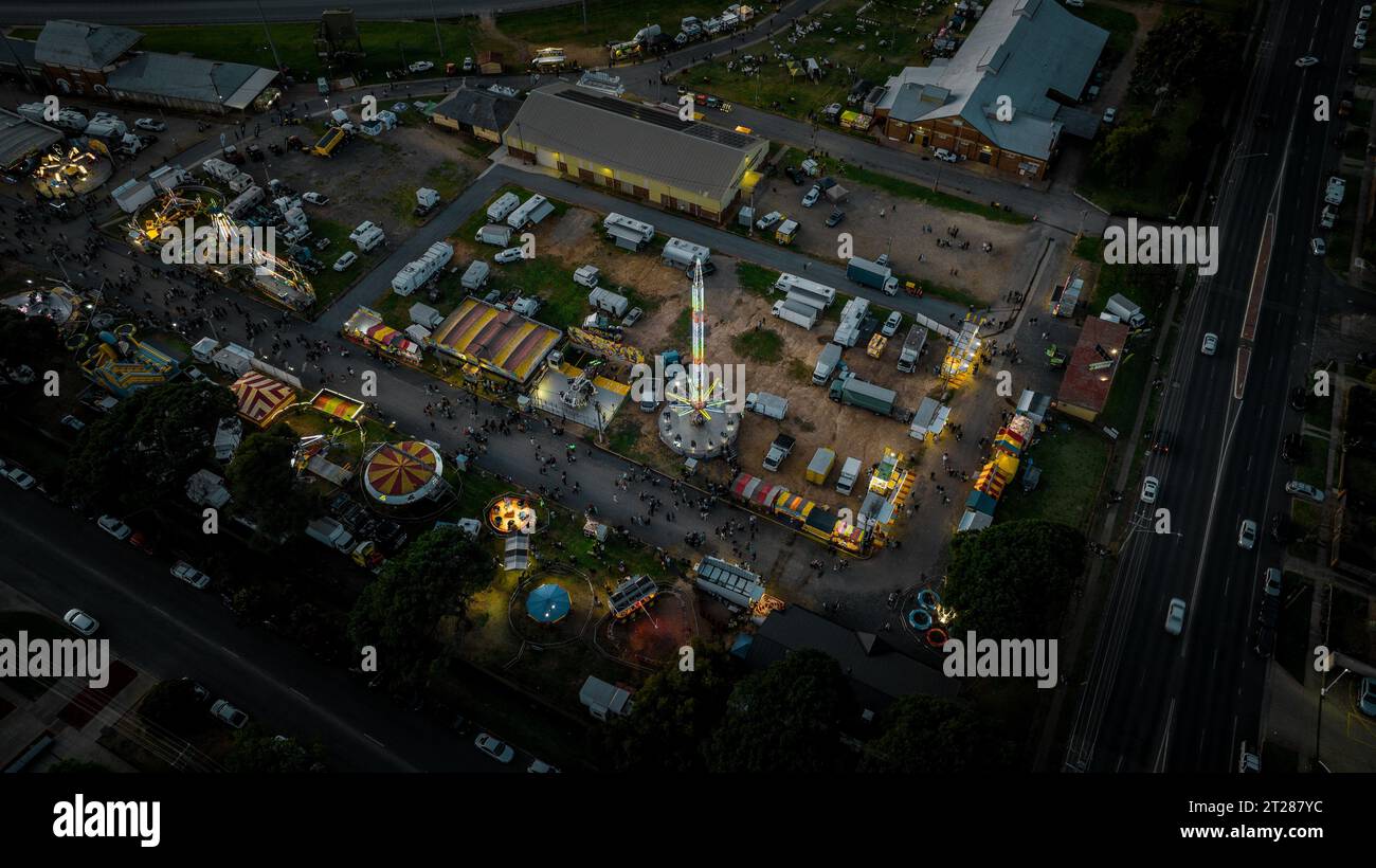 Aerial view of a lively amusement park at night, illuminated by ...