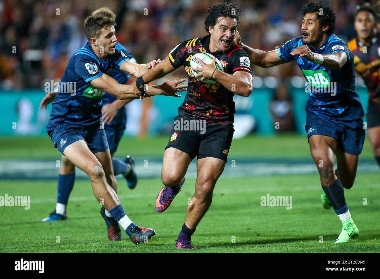 Matt Duffie and Melani Nanai of the Blues tackle James Lowe of the ...