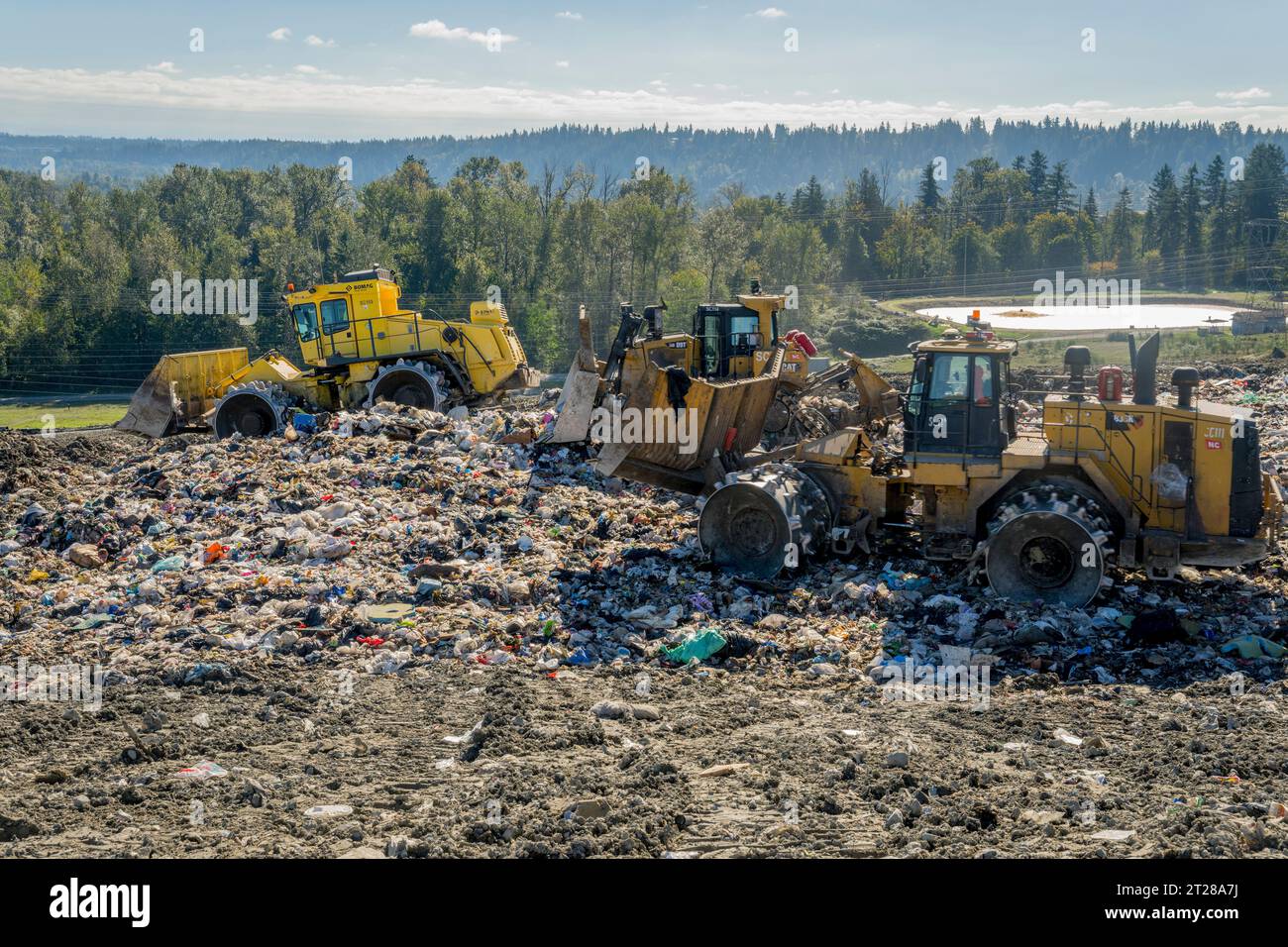 Heavy machinery is spreading the garbage at the King County Cedar Hills ...