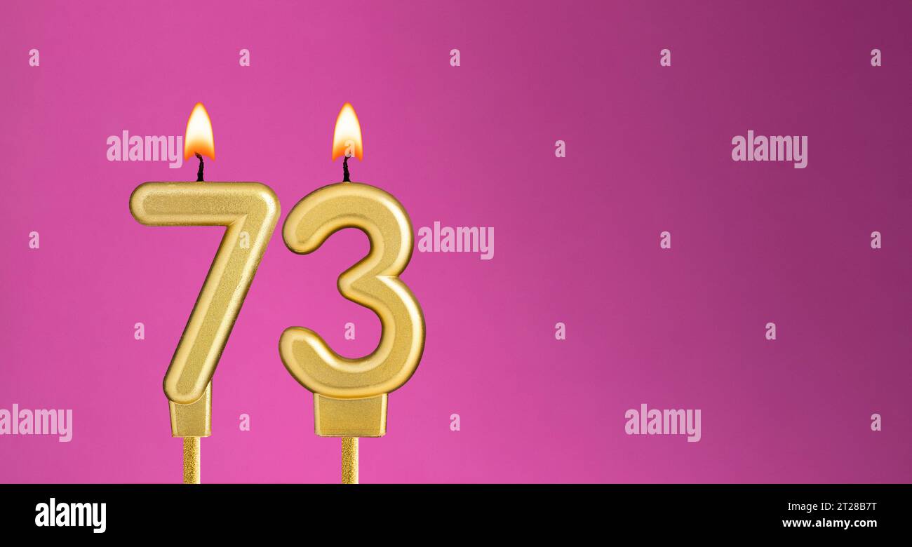 Candle number 73 in purple background - birthday card Stock Photo - Alamy