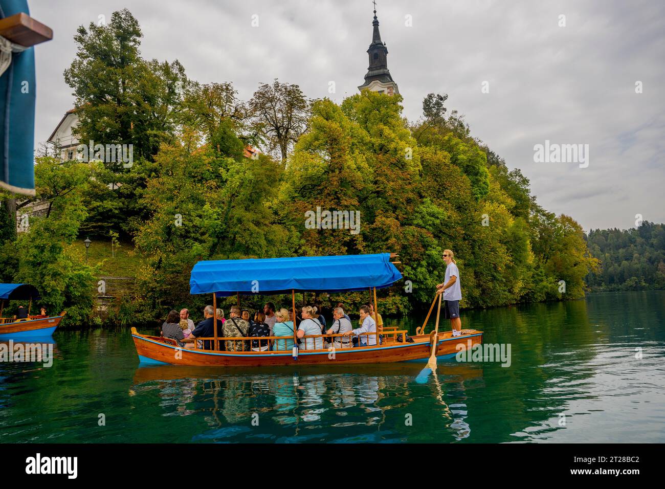 Tourists on a pletna boat, traditional boats handcrafted by locals of ...