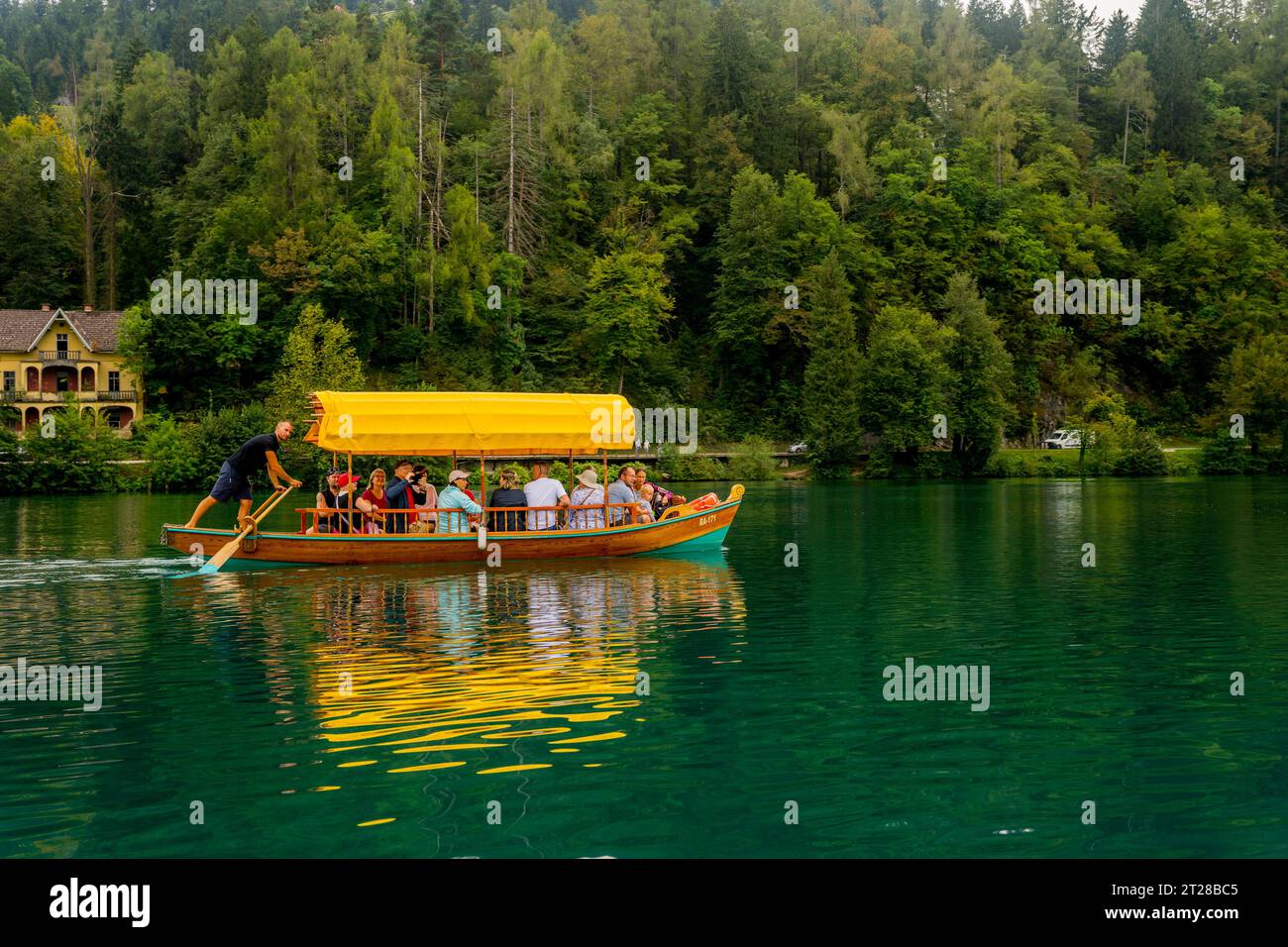 Tourists on a pletna boat, traditional boats handcrafted by locals of ...