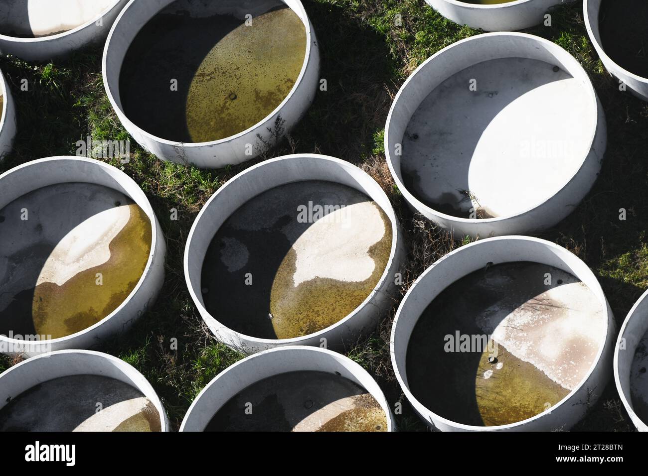 Aerial of concrete pots arranged within an industrial site, revealing ...