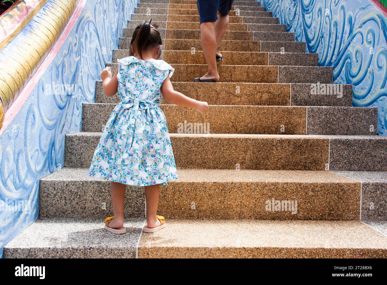 Thai little cute children girl walking on stair of Wat Khao Din Temple ...