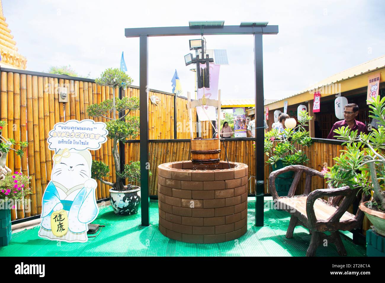 Vintage brick artesian water well and wooden bucket reel with rope in ...