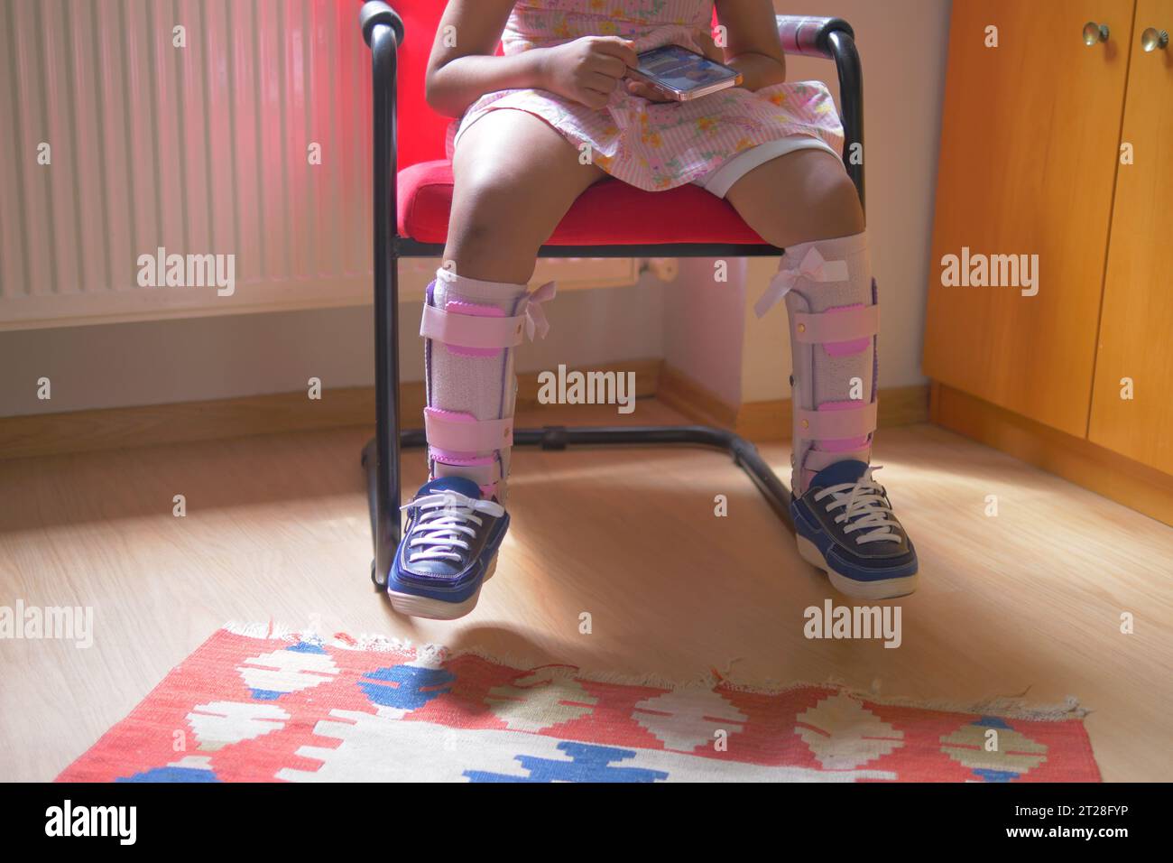Child cerebral palsy disability, legs orthosis Stock Photo - Alamy