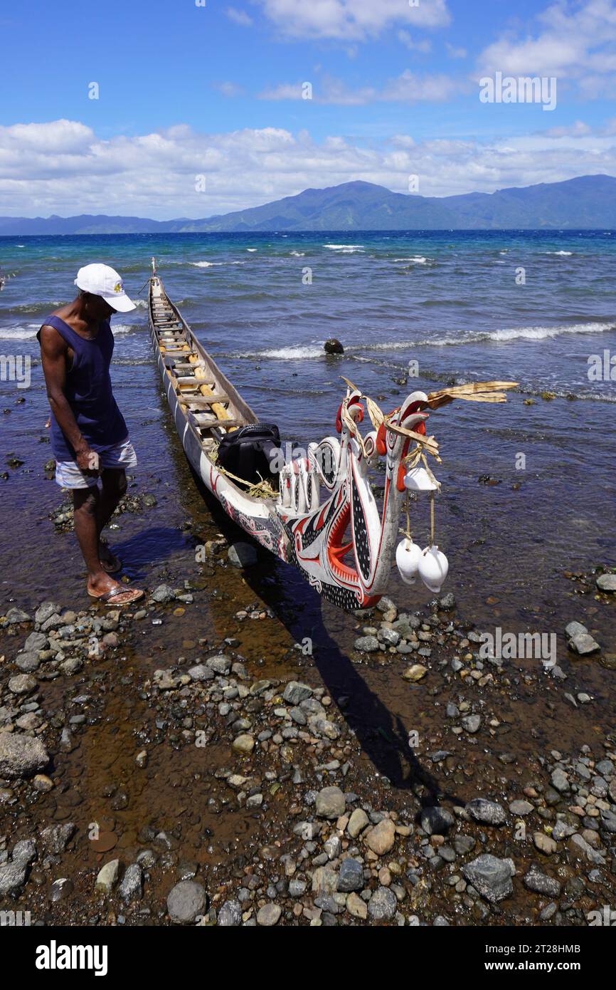 Man and War Canoe on the Shores of Alotau, Papua New Guinea Stock Photo ...