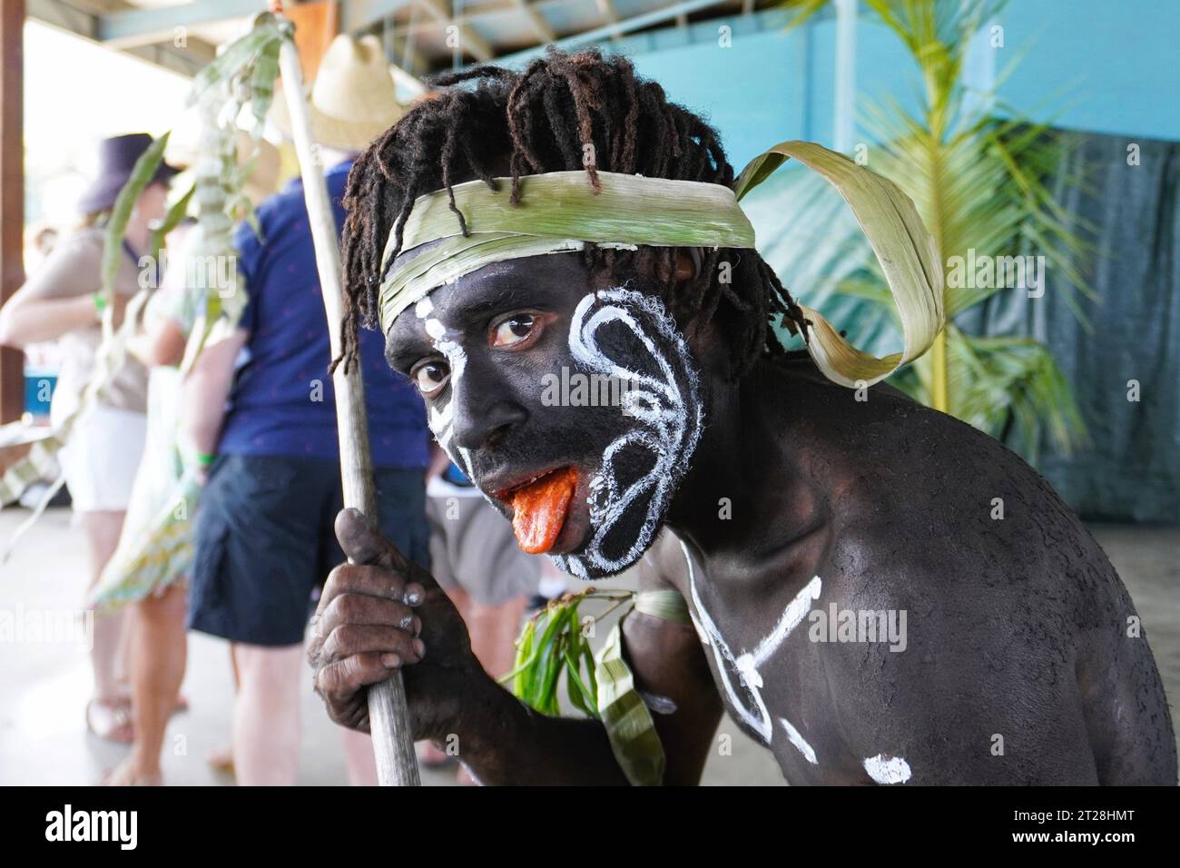 Traditionally Costumed Man poking out his Tongue stained Red from ...