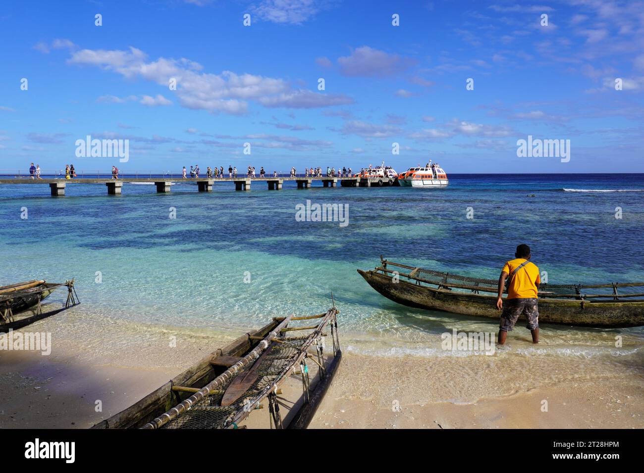 View of Traditional Outrigger Canoes and Cruise Passengers disembarking ...