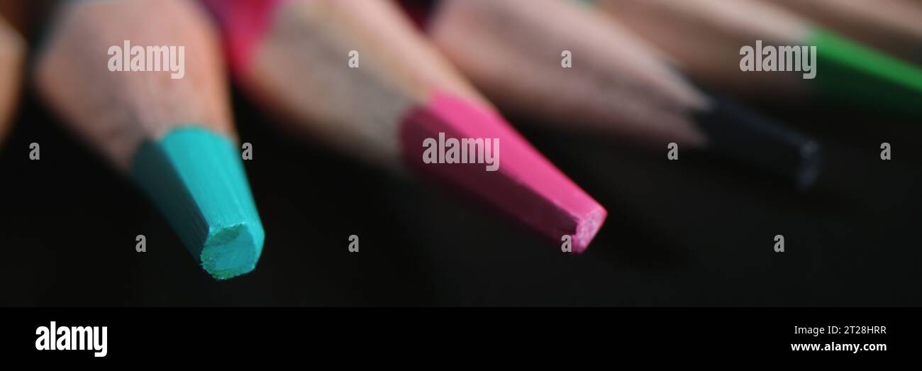 Sharpened multi-colored pencil tips on dark background Stock Photo - Alamy