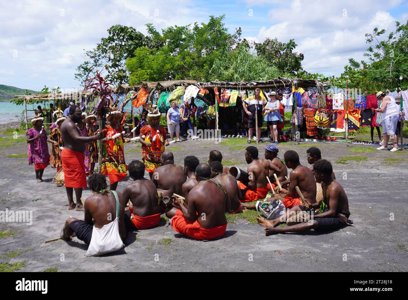 Seated Band and Women Dancers in Traditional Clothing in Front of ...