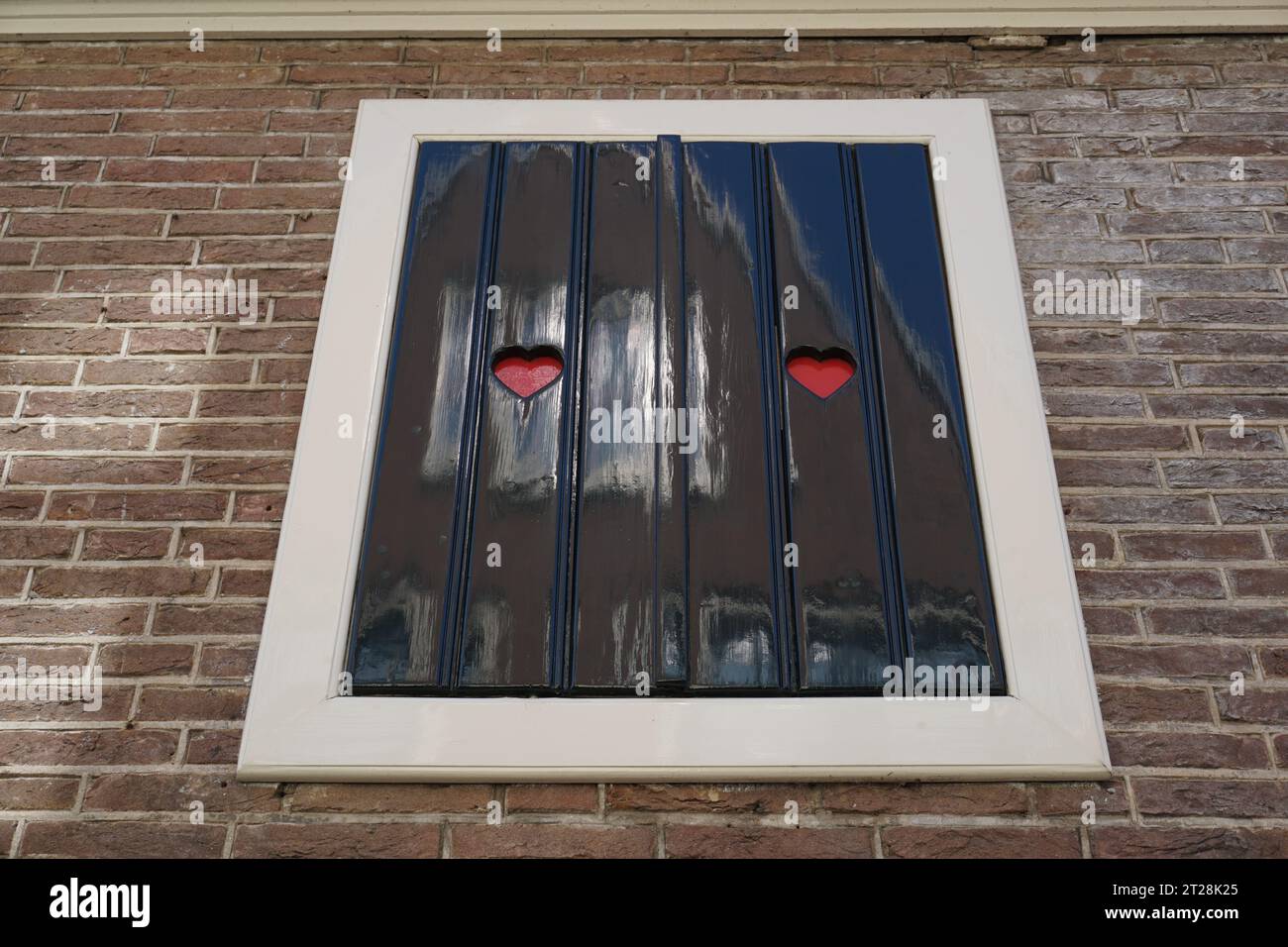 Typical traditional Dutch old fashioned closed wooden shutters with ...